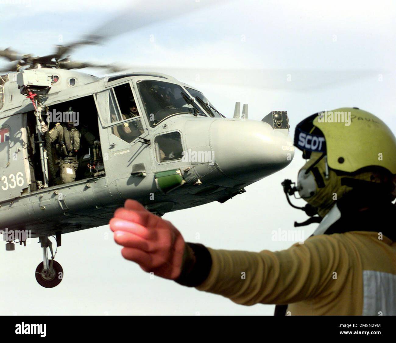 British Royal Navy Operator/Maintainer Paul Edwards guides a Lynx HMA-8 ...