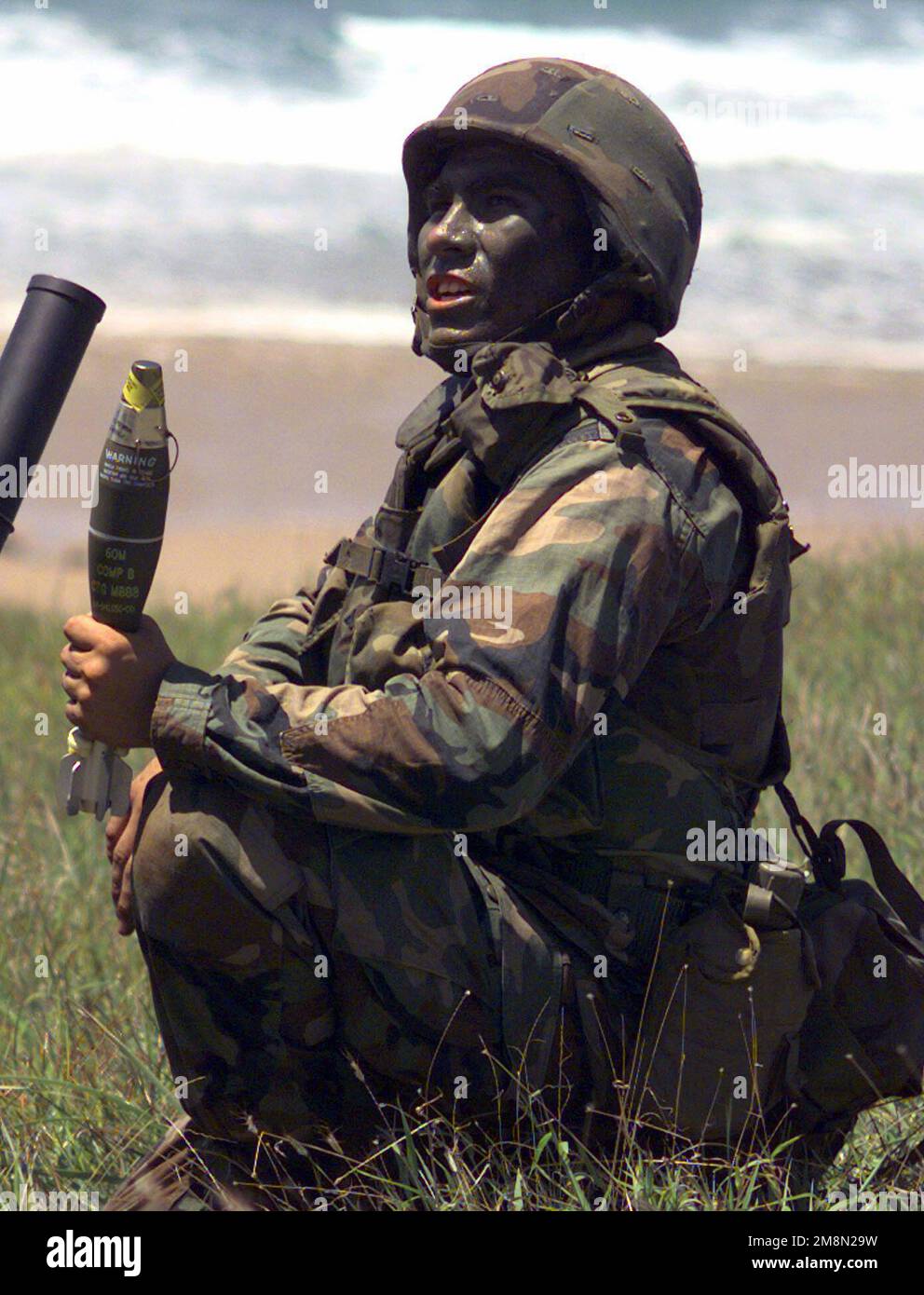 A mortarman stands by to load a round into a 60mm mortar at Townshend ...