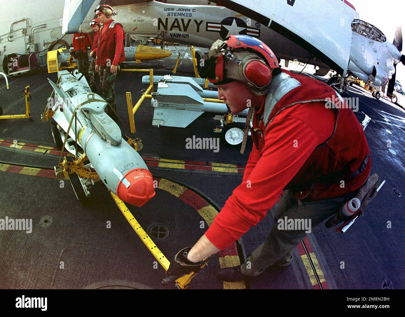 US Navy Aviation Ordnanceman 3rd Class Scott Nelson transports an AGM ...