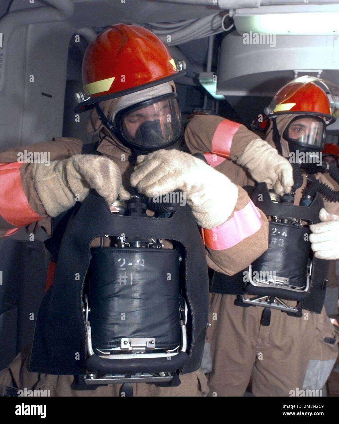 US Navy Firefighter's onboard Nimitz Class Aircraft carrier, USS JOHN C ...