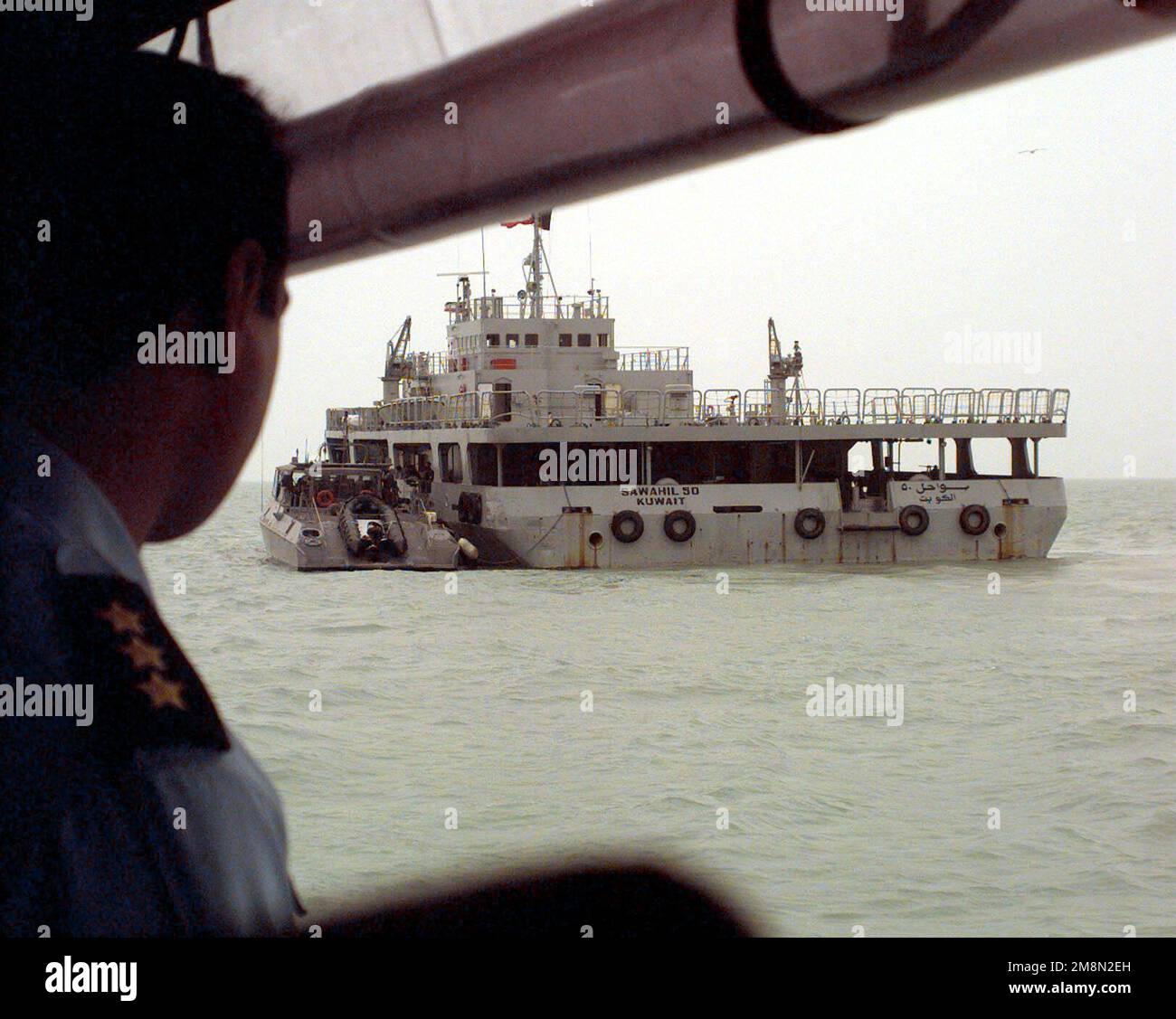 An officer of Kuwait's military watches as a U.S. Navy Mark V speed ...
