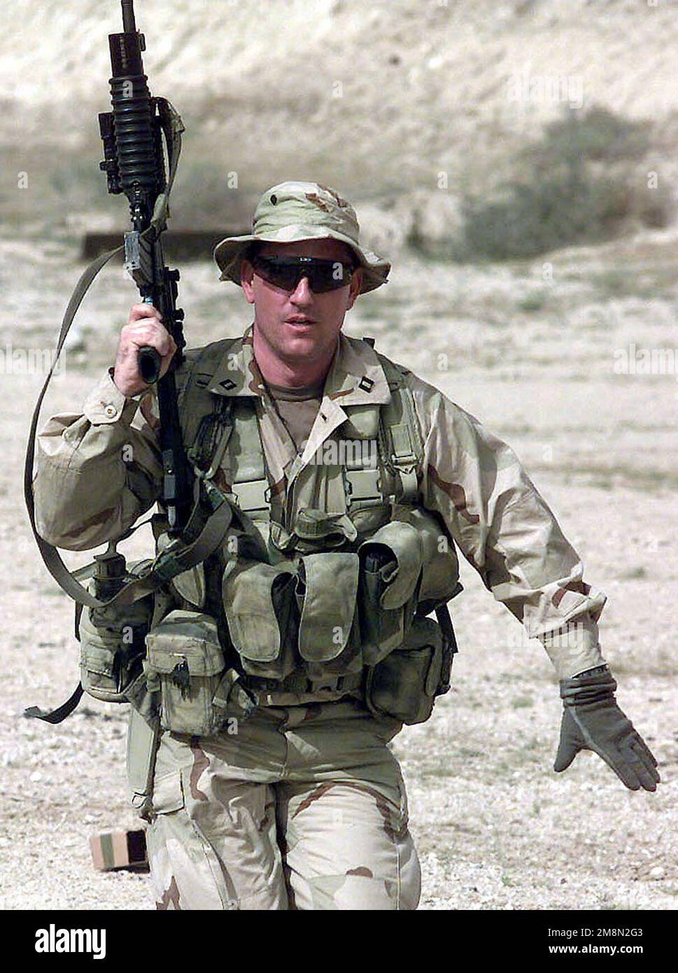 A US Navy Lieutenant, a SEAL from SEAL Team 8, runs down a firing range ...