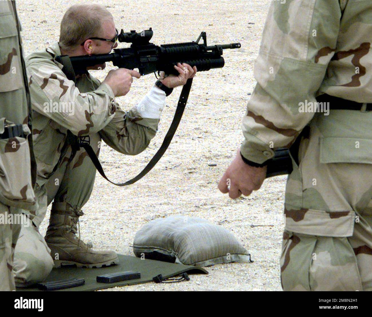 A US Navy SEAL, from SEAL team 8, shoots a Colt 5.56MM M4 Carbine, with ...