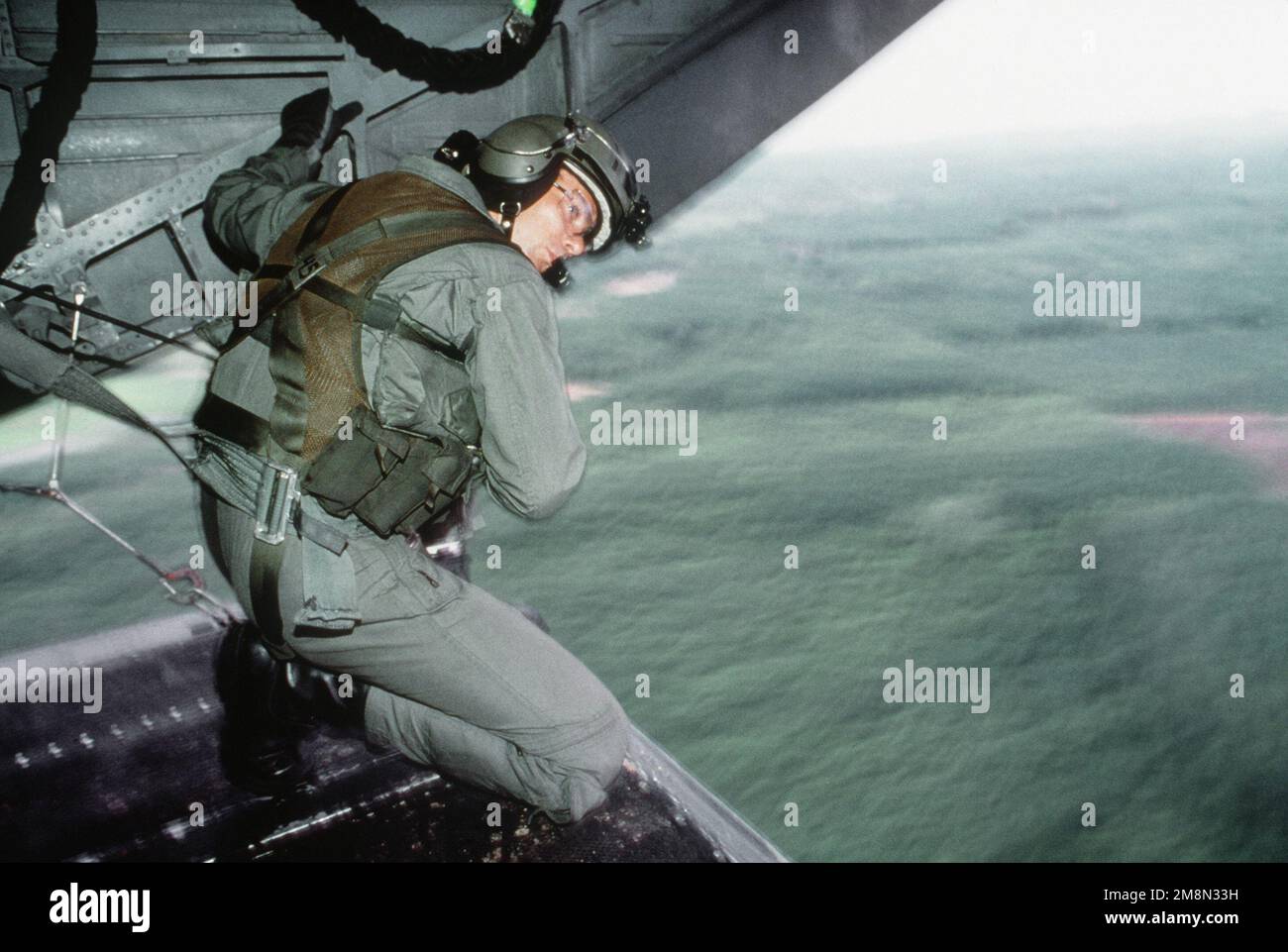 On the open ramp of a low flying C-130 Hercules assigned to Yokota AB ...