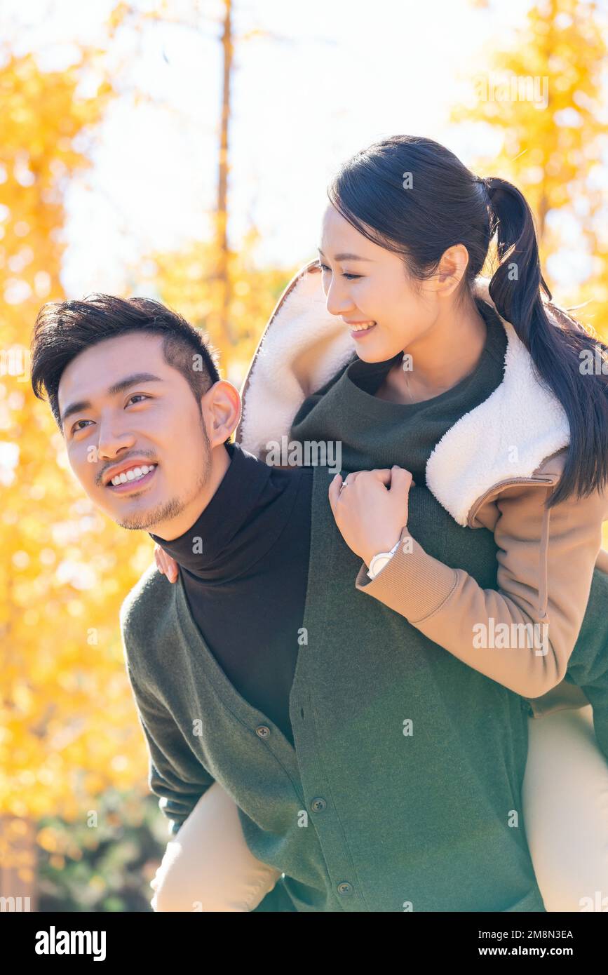 Young lovers autumn gingko forest Stock Photo - Alamy