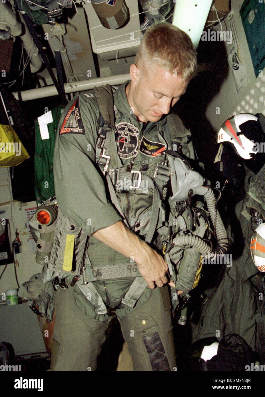 US Navy Lieutenant (LT) Chris Adams dons survival gear in preparation ...