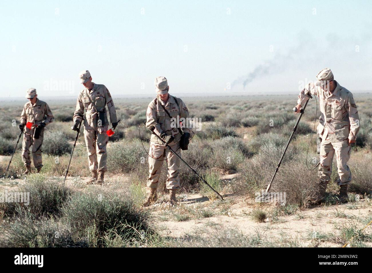 Shot of Explosive Ordnance Disposal troops clearing an area to ensure ...