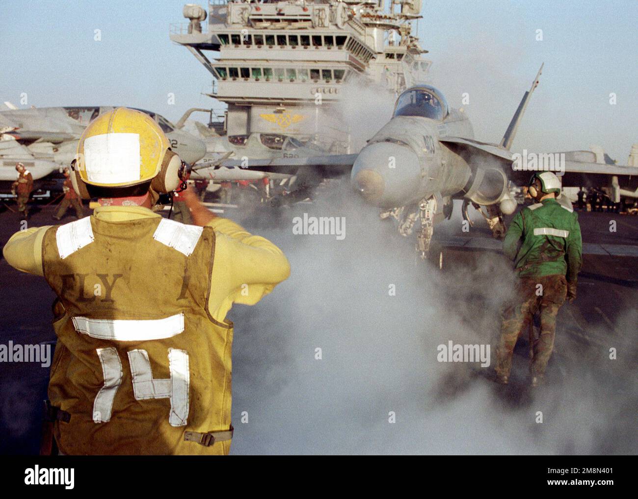 Through a cloud of steam, US Navy Aviation Boatswain's Mate 1ST Class ...