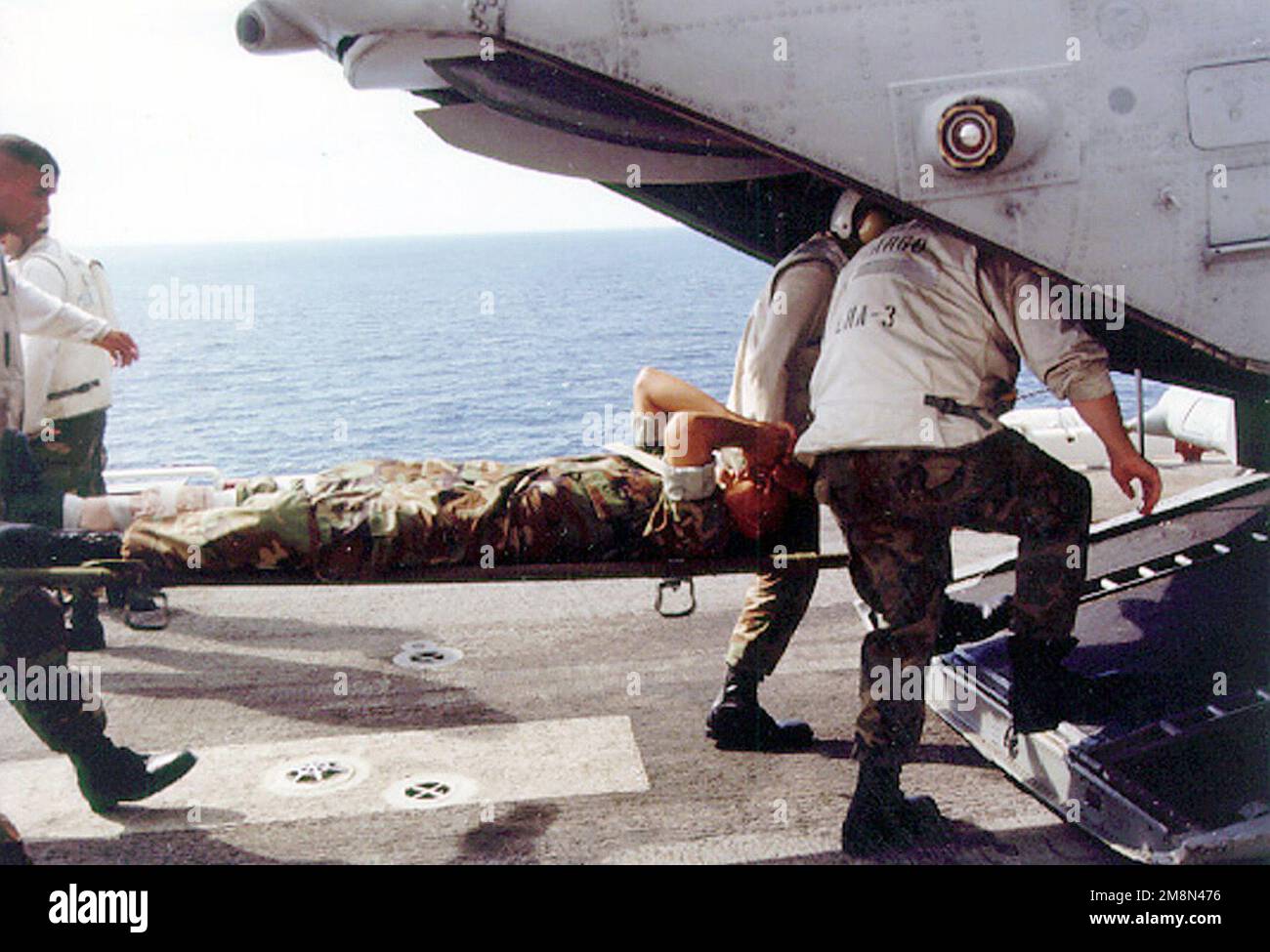 US Navy Stretcher bearers remove a casualty from a CH-46 Sea Knight ...