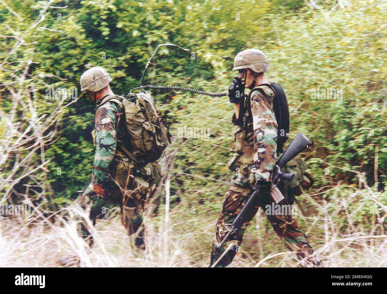 US Marine Corps Private First Class Edward C. Walsh, armed with an M16 ...