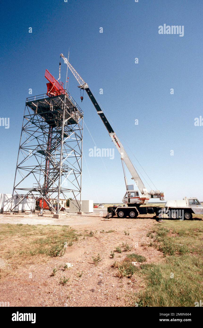 A large crane operated by a civilian contractor is being used to remove ...