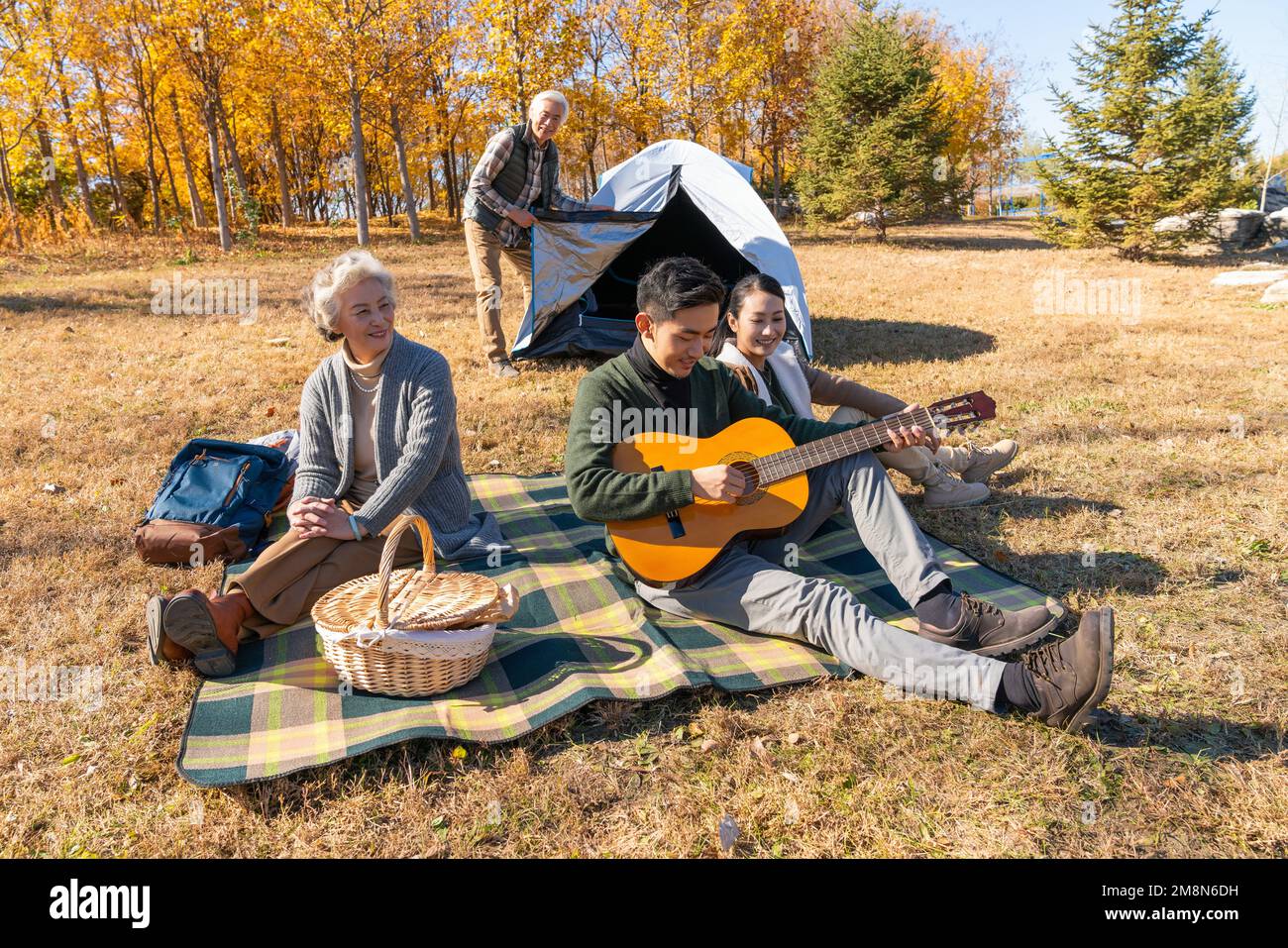 Happy family autumn camping out for a picnic Stock Photo - Alamy