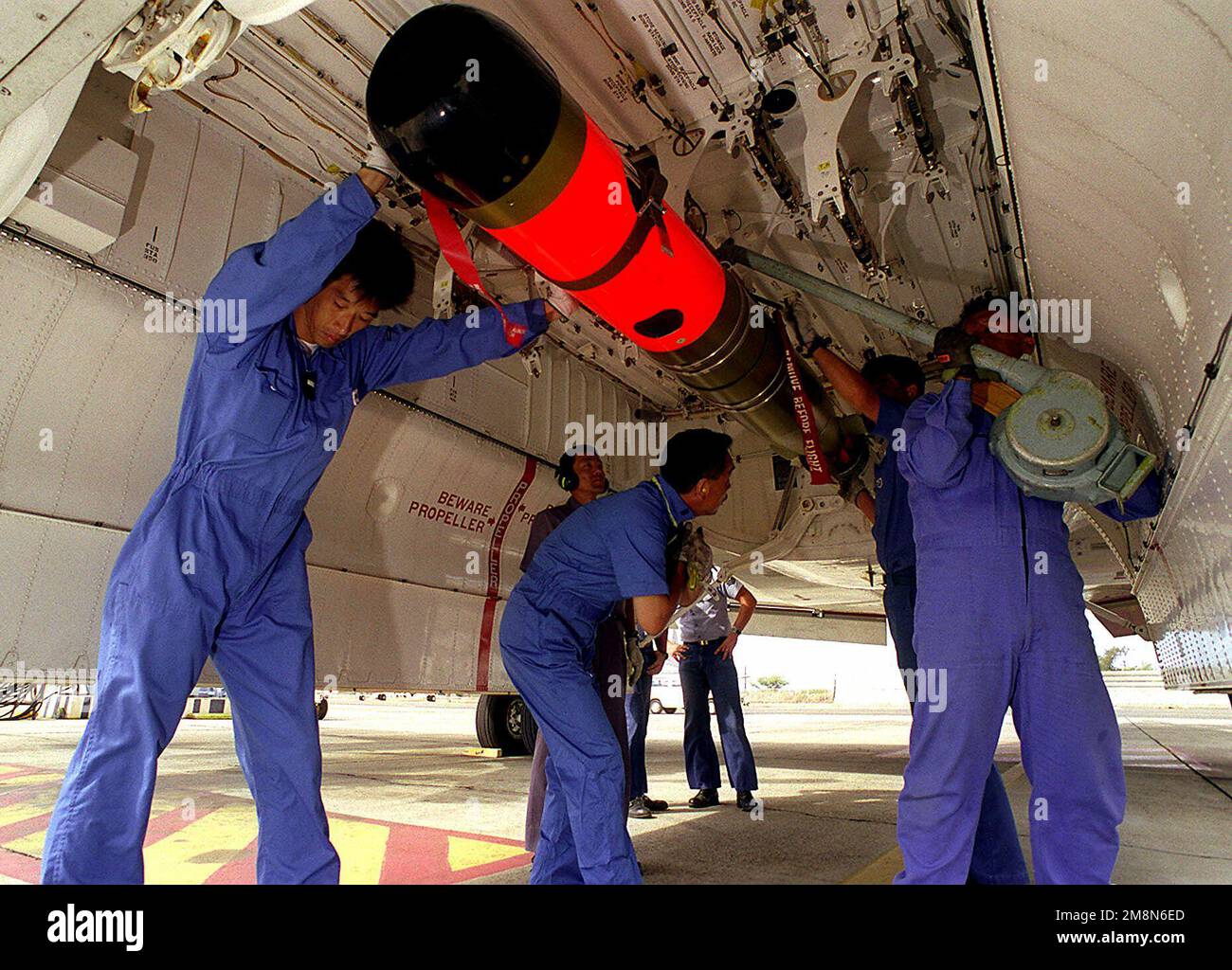 Japan Maritime Self Defense Force (JMSDF) aircrew load a Mark 46 air ...