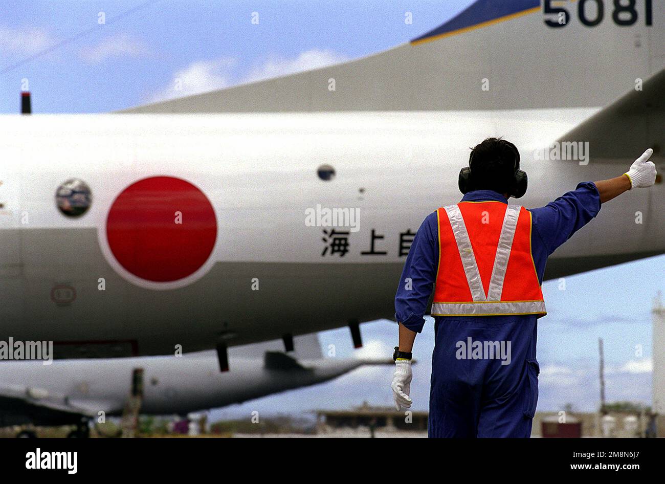 A member of the Japan Maritime Self Defense Force P-3C ground crew ...
