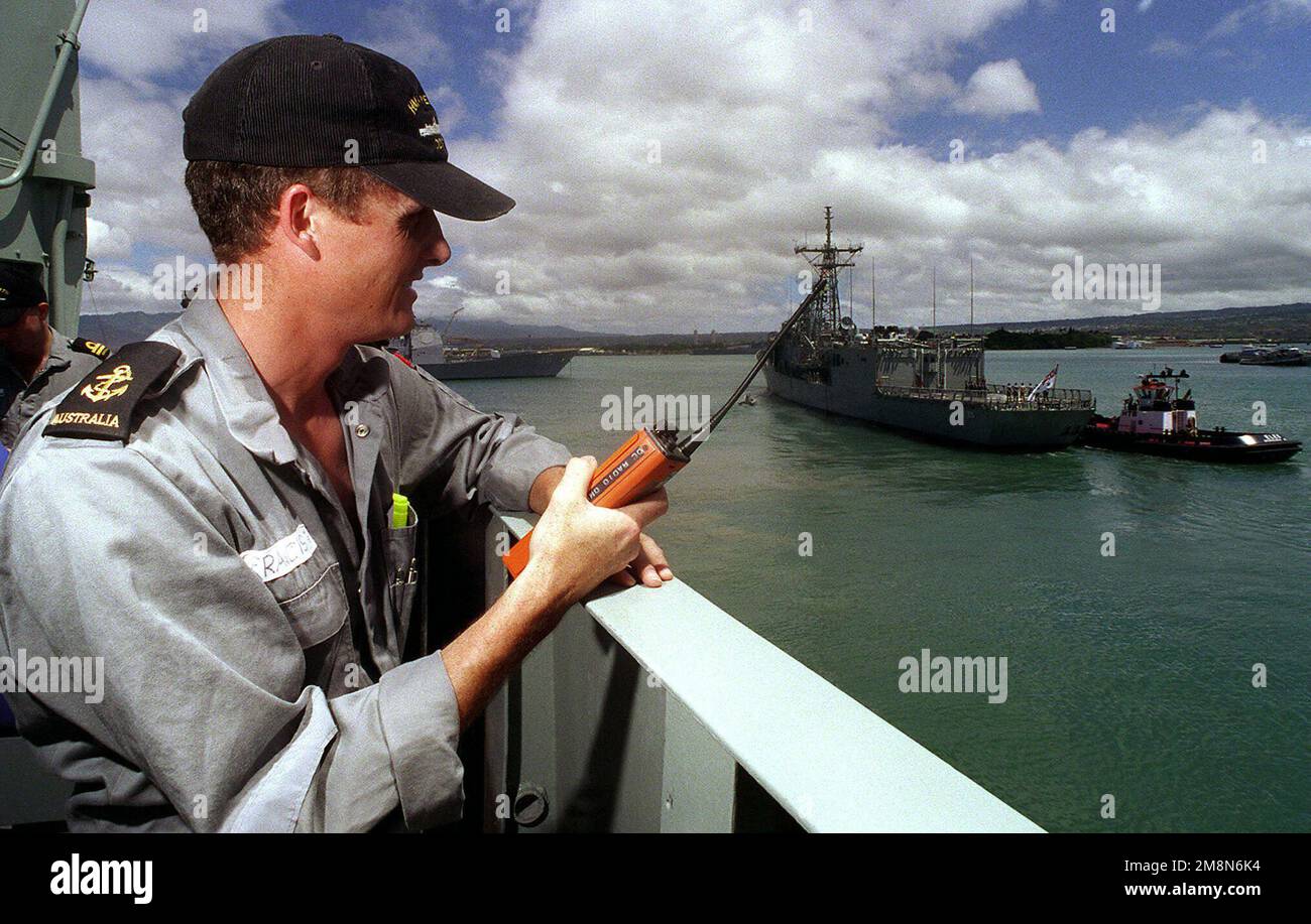 As the Australian HMAS MELBOURNE (FFG 5) sails out of Pearl Harbor with ...