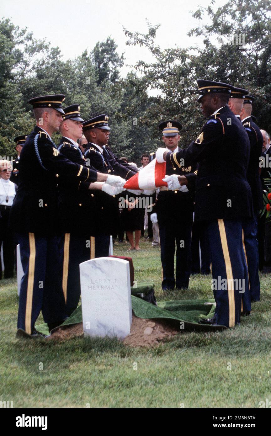 Members of Charlie Company, 3rd Infantry casket team fold an American ...