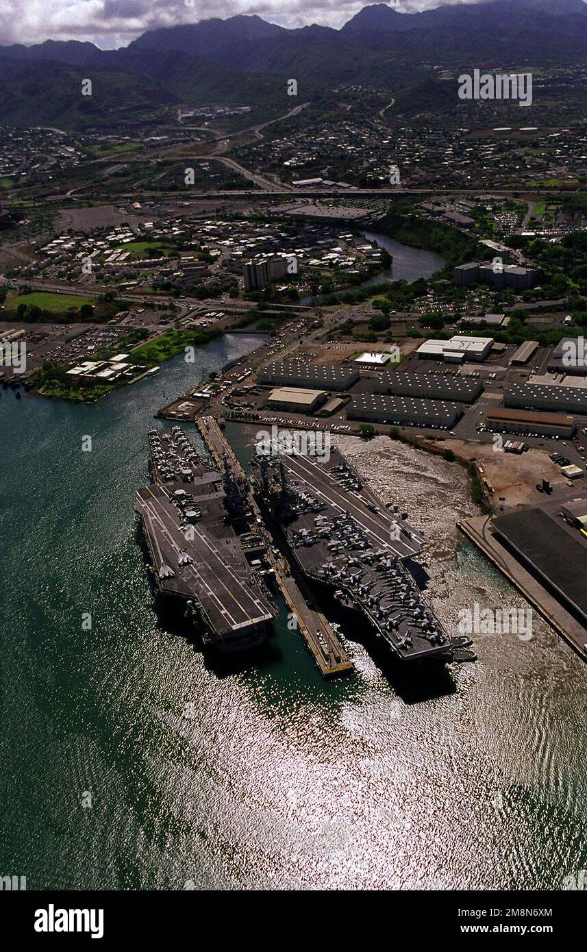 An aerial view of the aircraft carriers USS INDEPENDENCE (CV 62), left ...