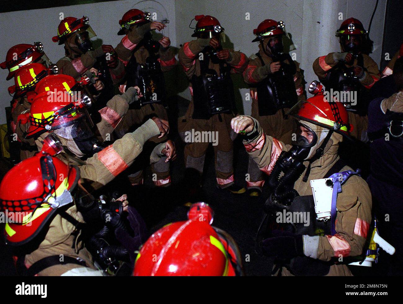 Members of damage control team on aboard the auxiliary command ship USS ...