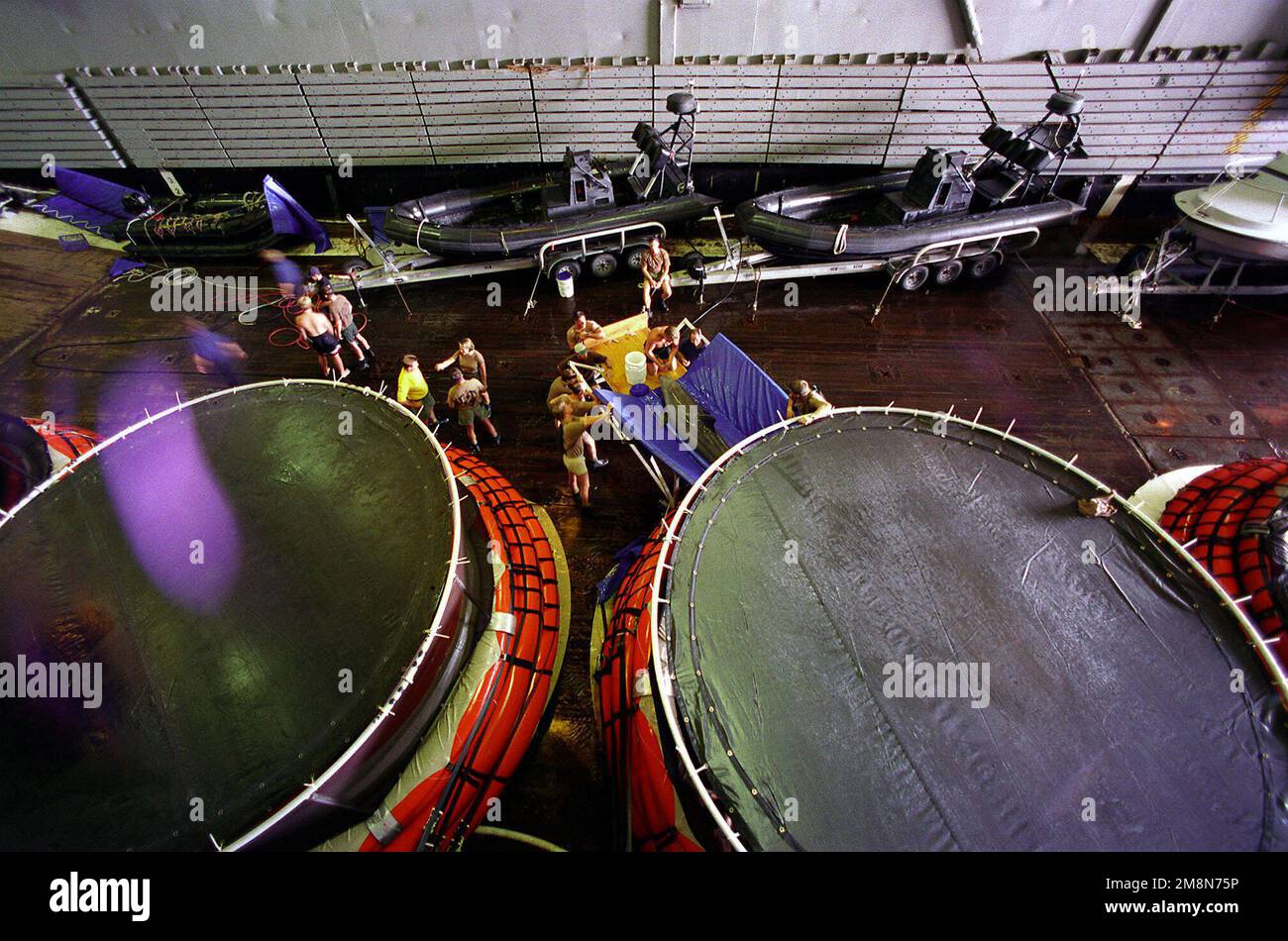 With holding pens in the foreground of the well deck on the Austin ...