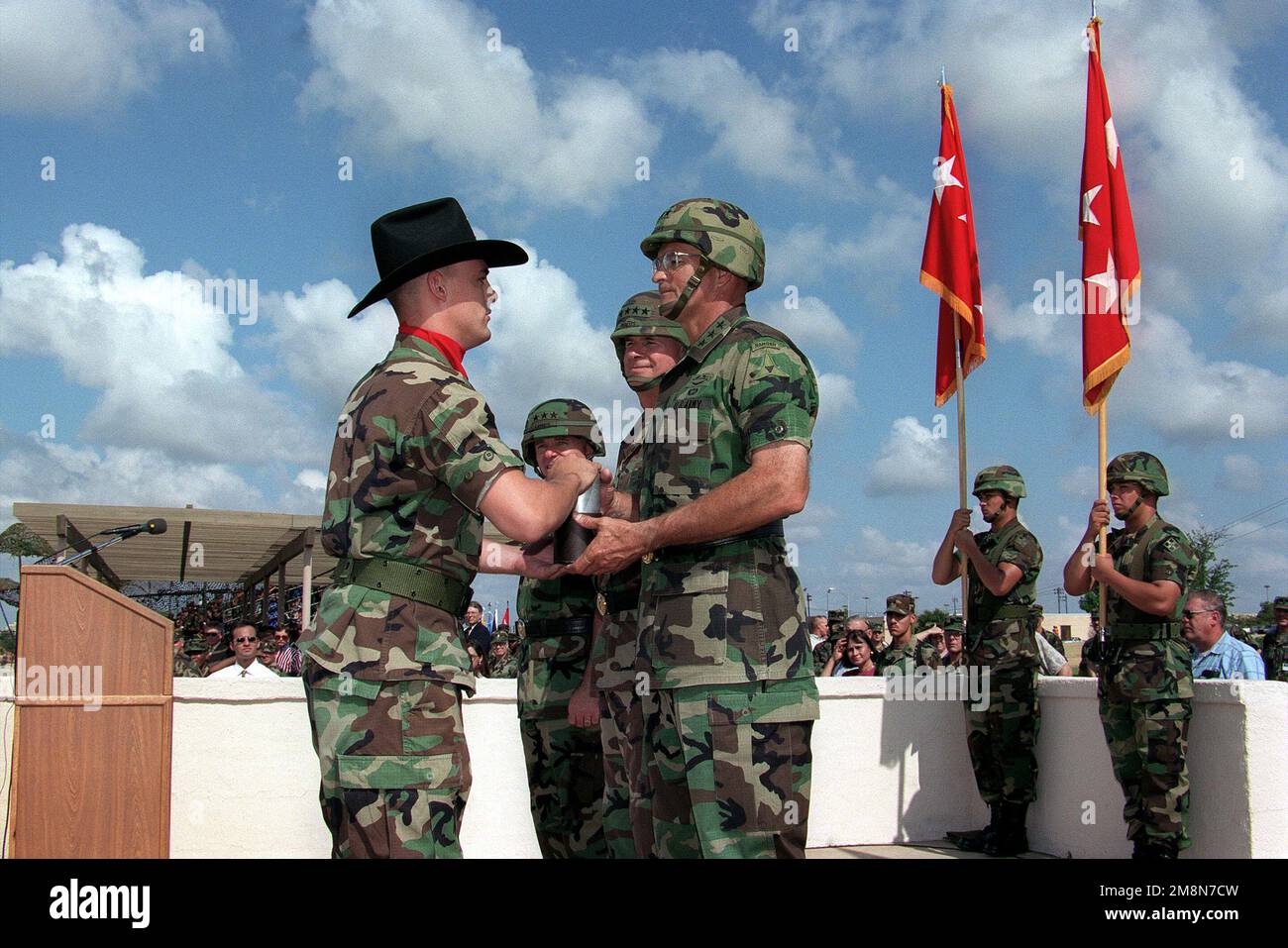 A member of III Corps (wearing black cowboy hat) presents the outgoing ...