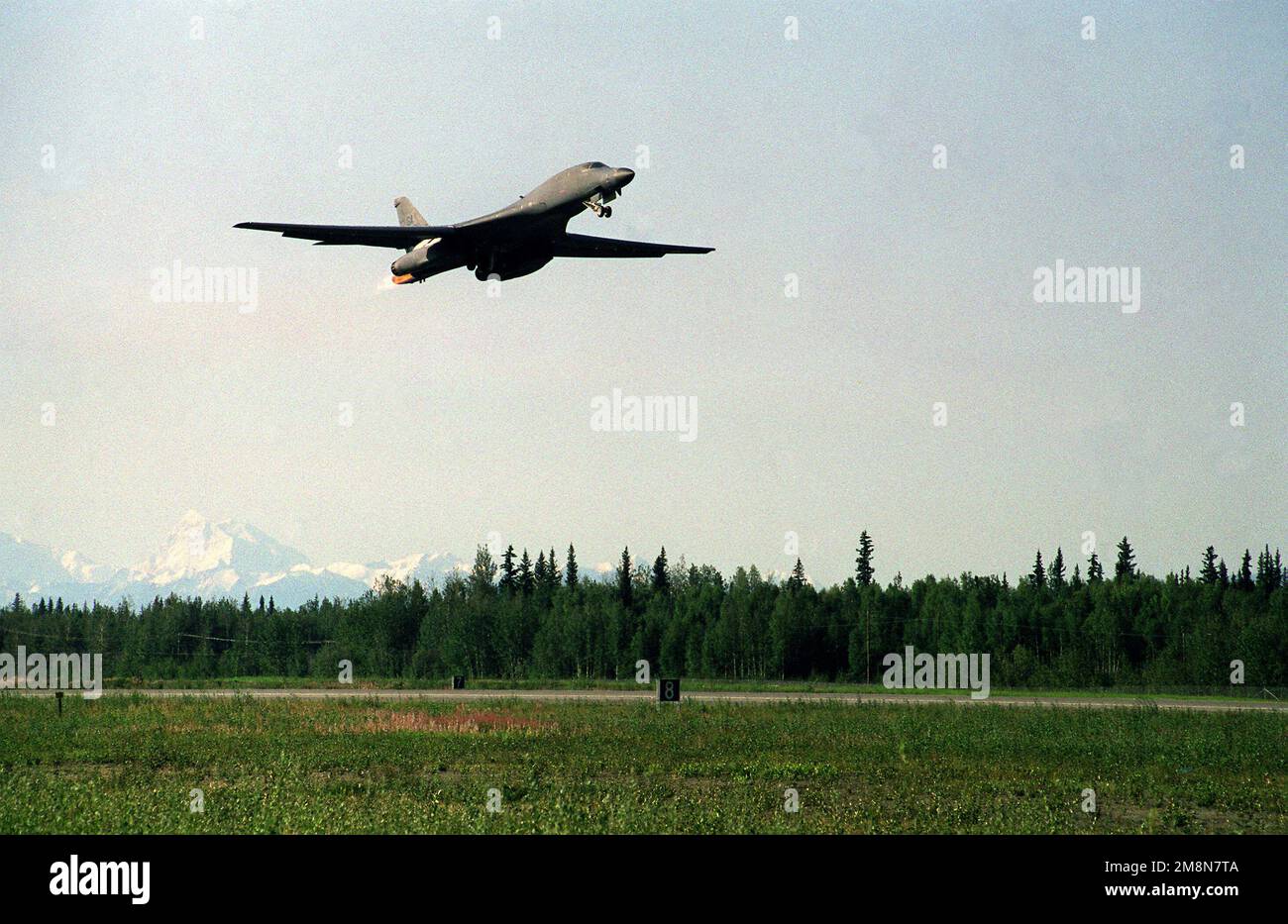 Right side medium shot from a low angle looking up at a USAF B1-B ...