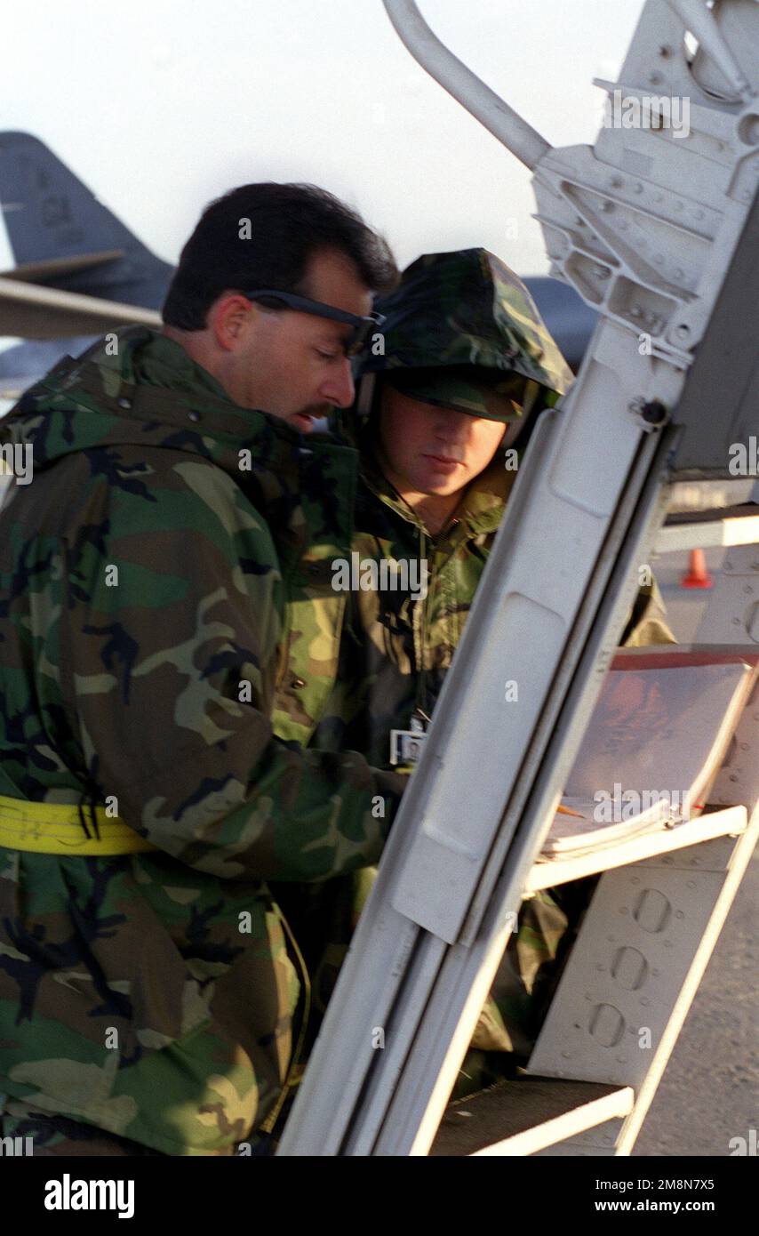 USAF Techincal Sergeant Tommy Sutherland (Left) goes over a B1-B Lancer ...