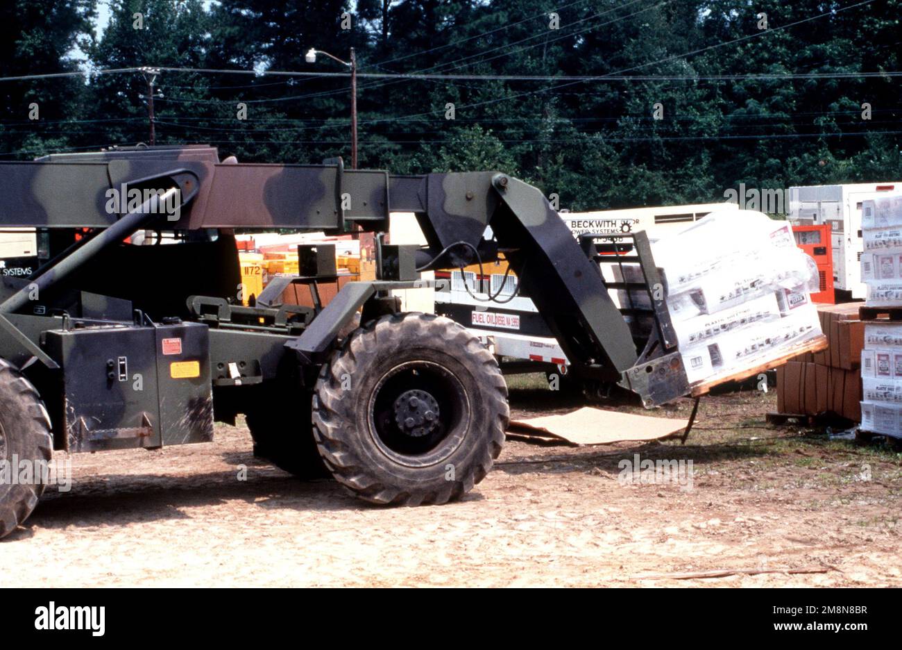 A TRAK All-Terrain Lifter Army System (ATLAS) positions a pallet of ...