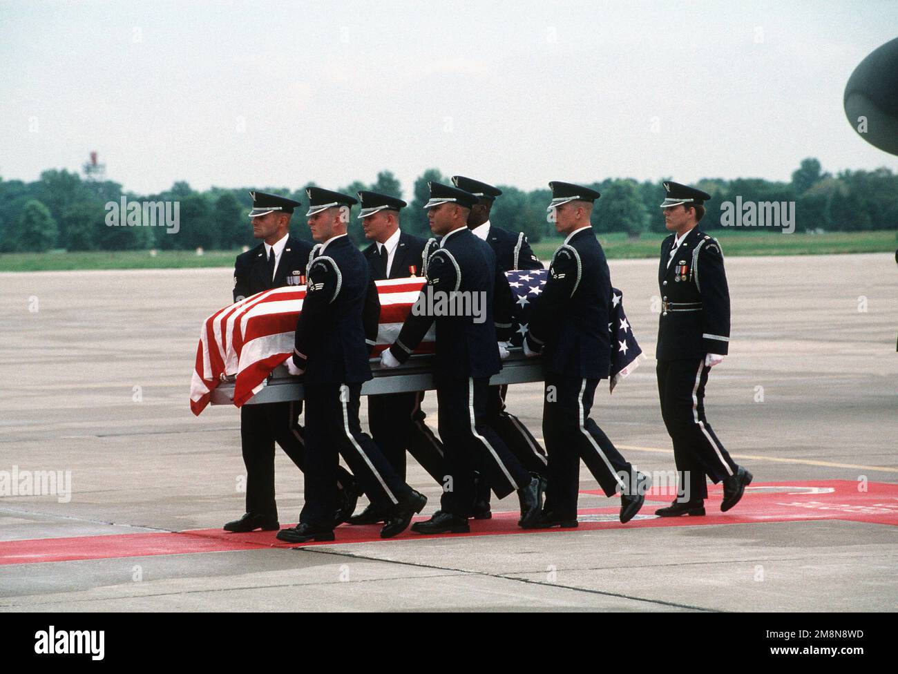 United States Air Force Color Guard walk along a red carpet placed on ...