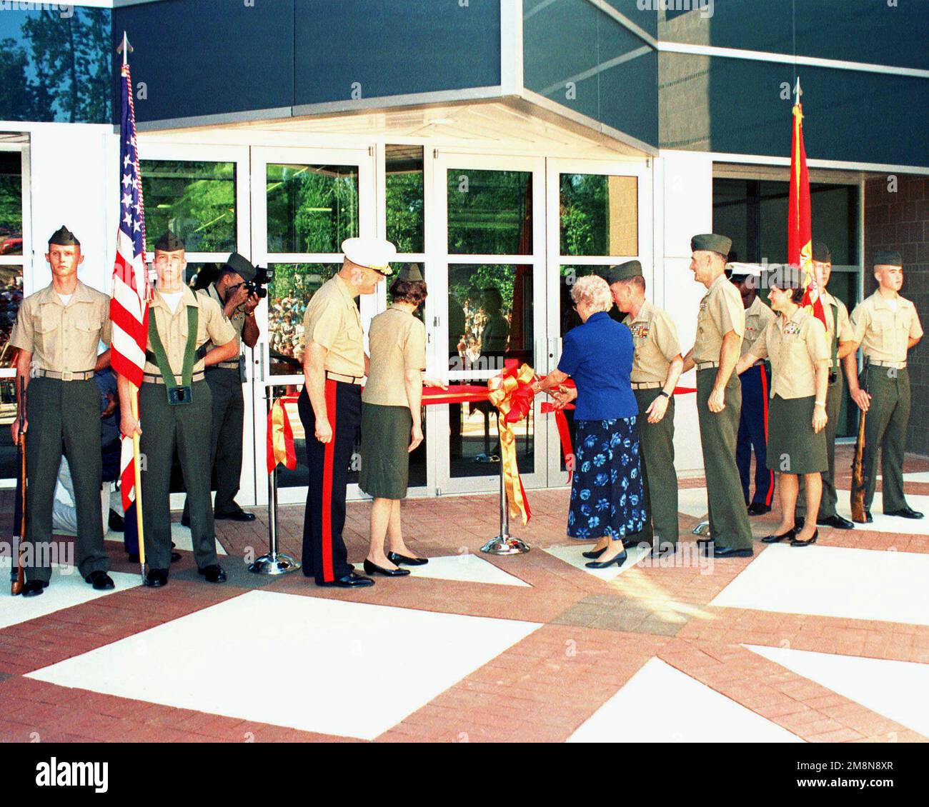 Flanked by a Marine Honor Guard, Mrs. Dorthy H. Marsh (center right ...