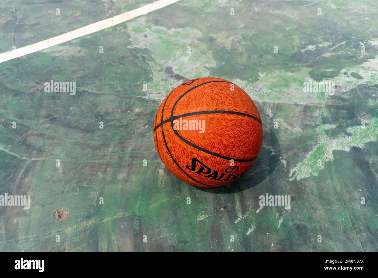 Orange basketball lying in the middle of the basketball court close up ...