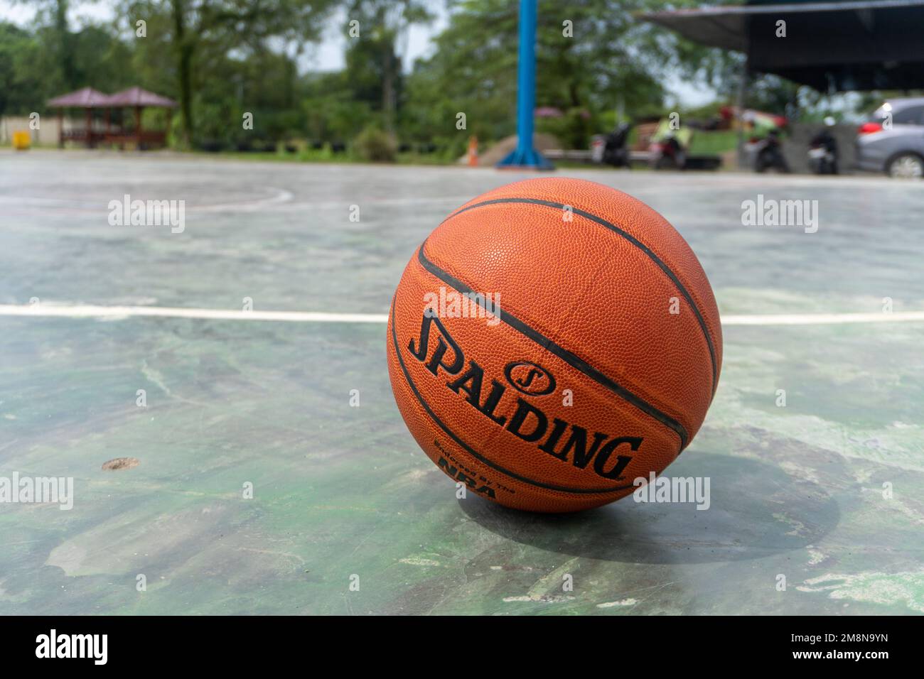 Orange basketball lying in the middle of the basketball court close up ...