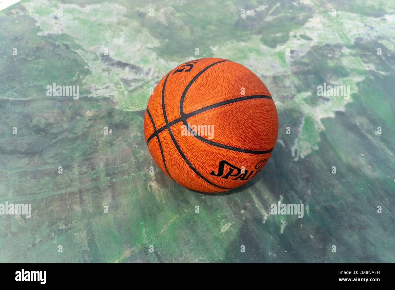 Orange basketball lying in the middle of the basketball court close up ...