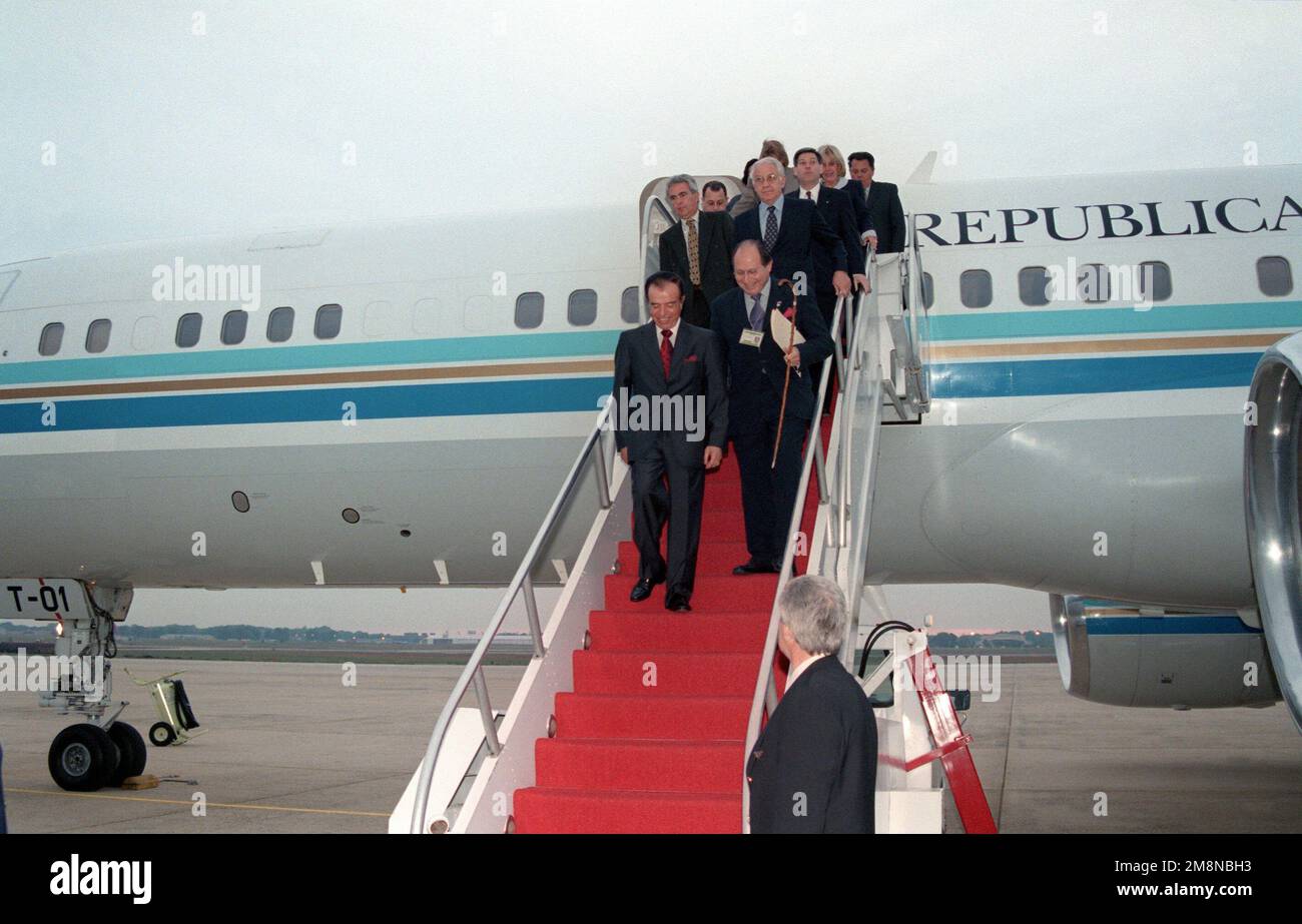 Dr. Carlos S. Menen, President of Argentina, emerges from his aircraft ...