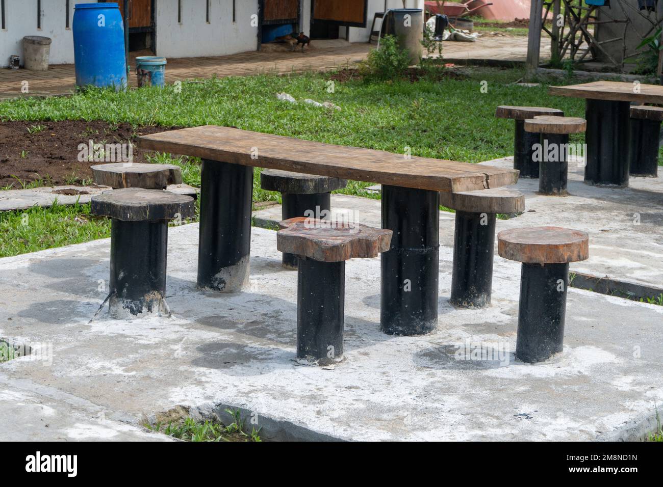 Outdoor cafe with wooden benches in the middle of a city park ...