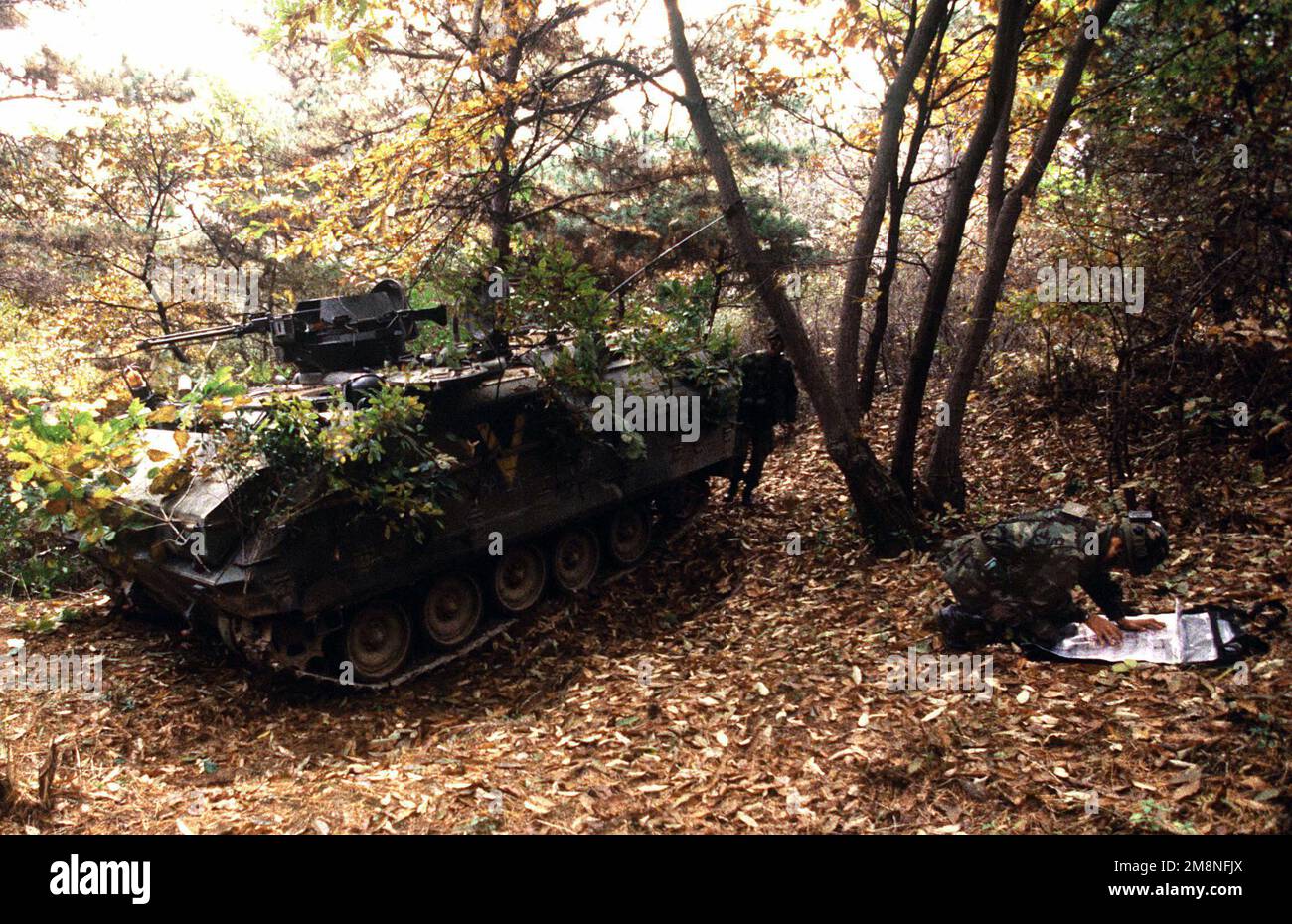 A Republic of Korea Army (ROKA) soldier reviews battle plans near his ...