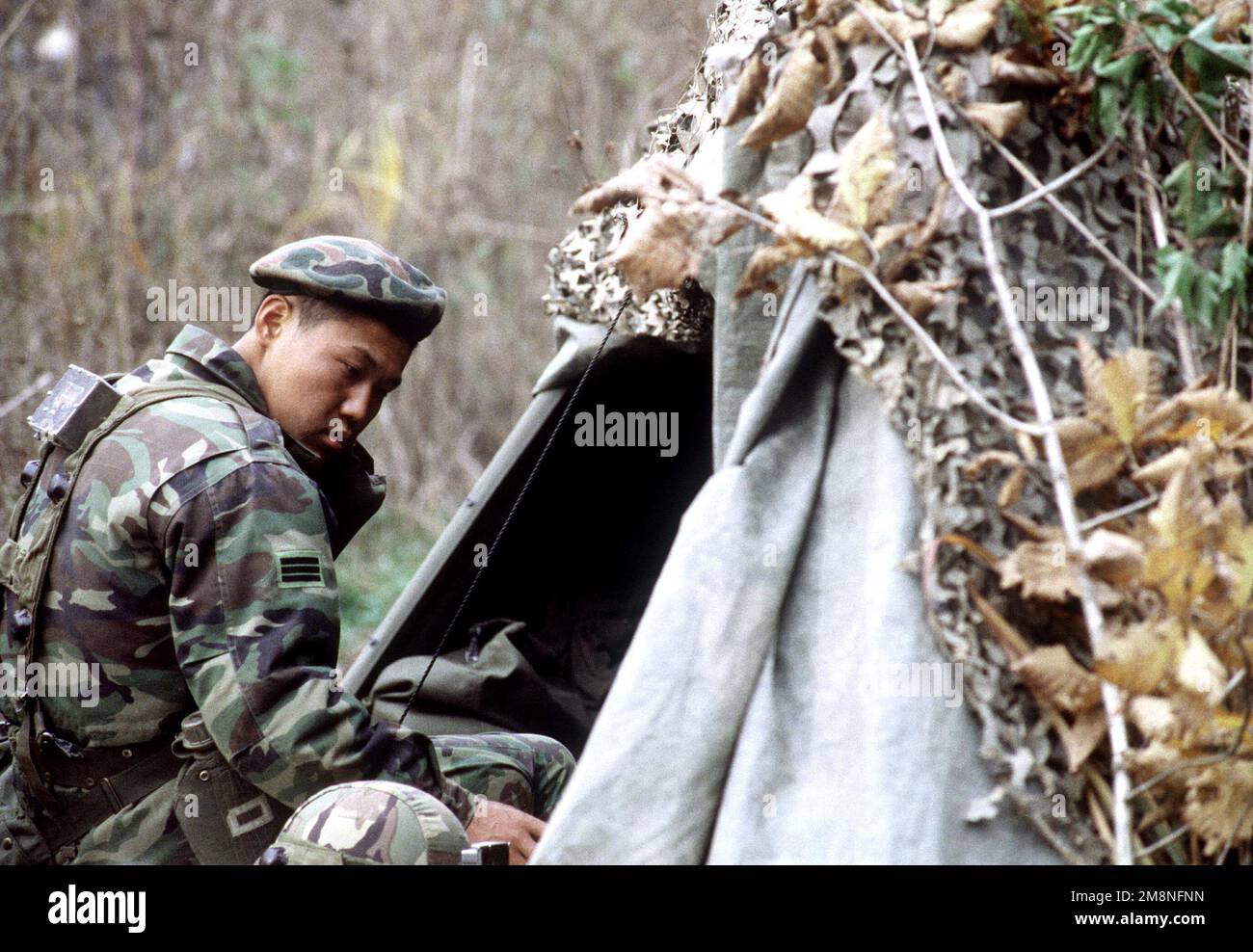 A Republic of Korea Army (ROKA) soldier relaxes in front of his tent at ...