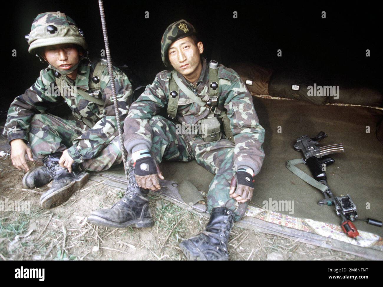 Republic of Korea Army (ROKA) soldiers relax in front of their tent at ...