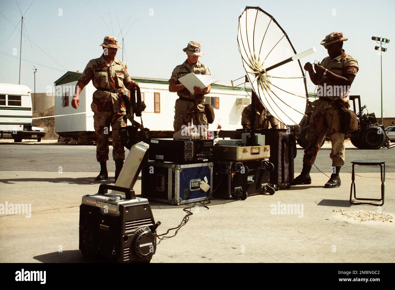 Members of a U.S. Army combat camera crew operate a satellite video ...