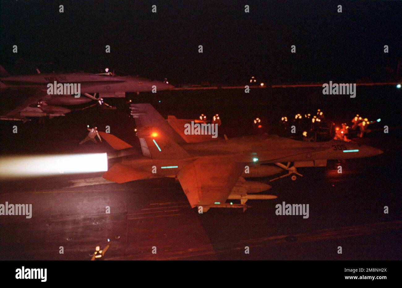 With its afterburner blazing, a U.S. Navy F/A-18 Hornet, belonging to ...