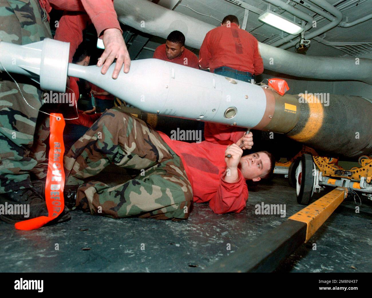 An aviation ordnanceman on board the USS ENTERPRISE (CVN-65) tightens a ...