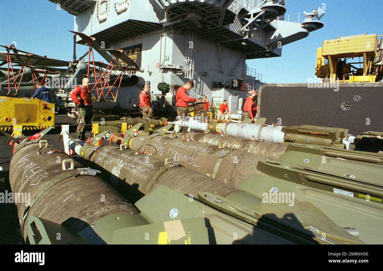Aviation ordnancemen ready bombs for loading onto various aircraft on ...