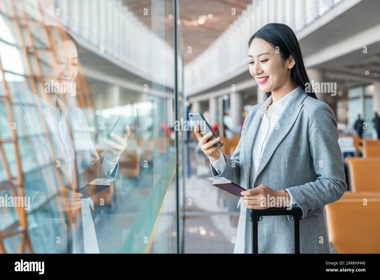 The use of mobile phones business lady in the airport lounge Stock ...