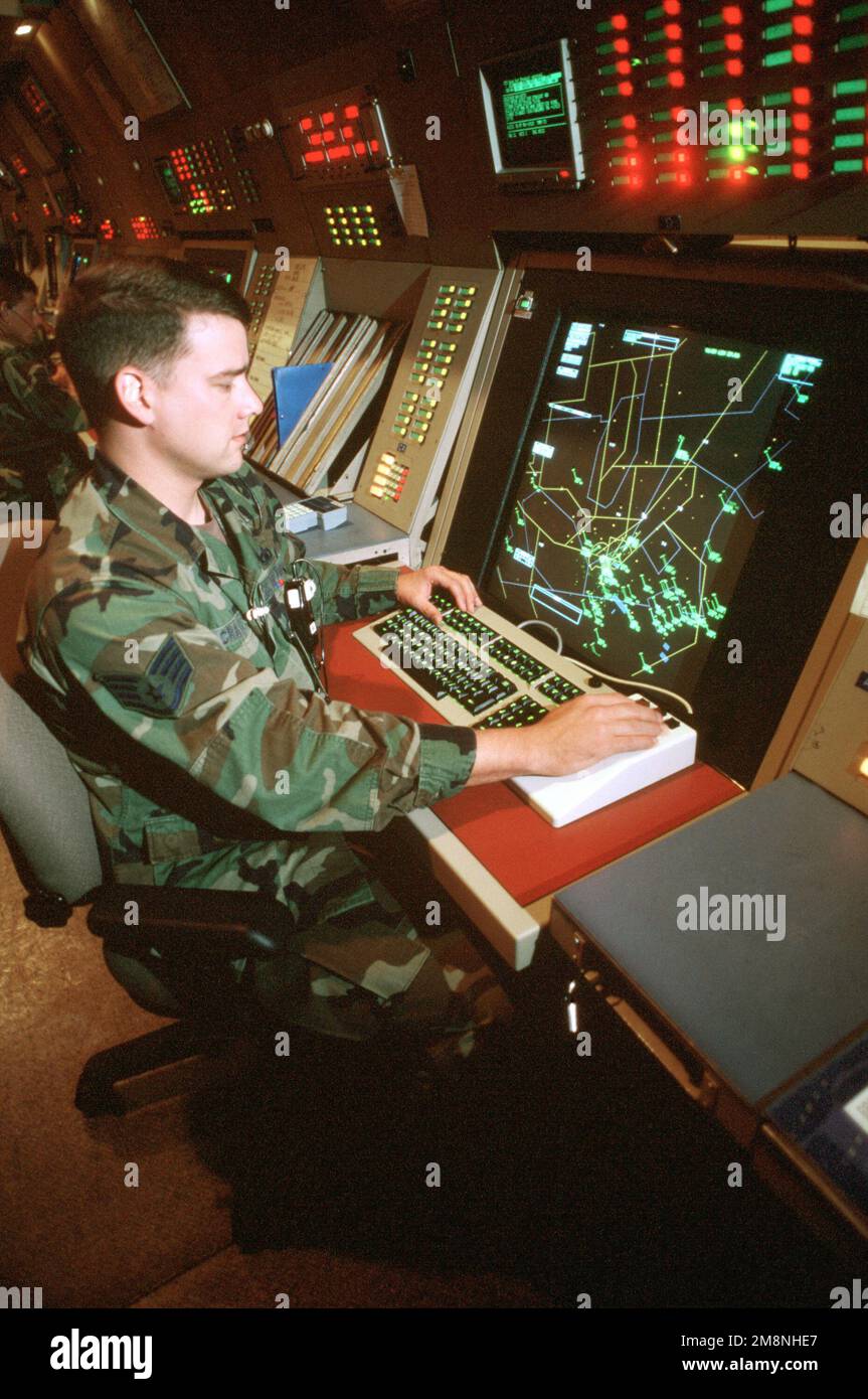 Right side profile of an unidentified USAF STAFF Sergeant as he sits at ...