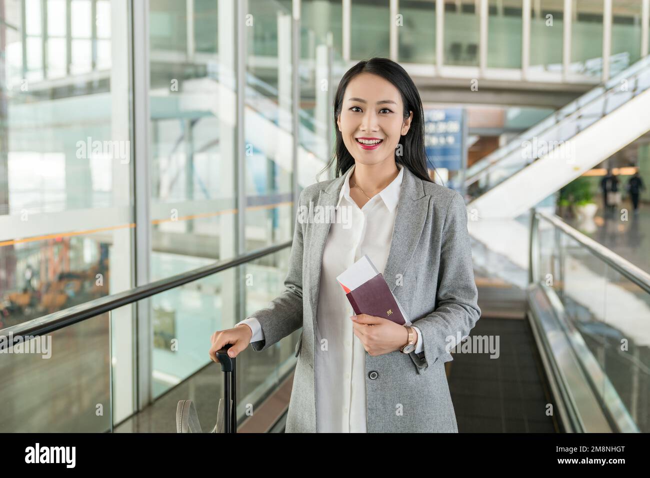 Asian lady holding passport hi-res stock photography and images - Alamy