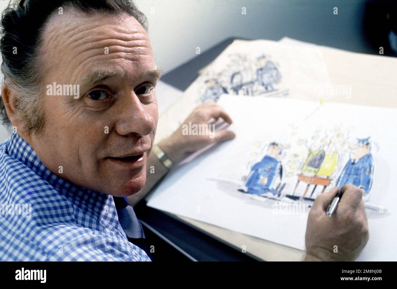 An over the shoulder shot of US Air Force News Service Artist Bob Goode ...