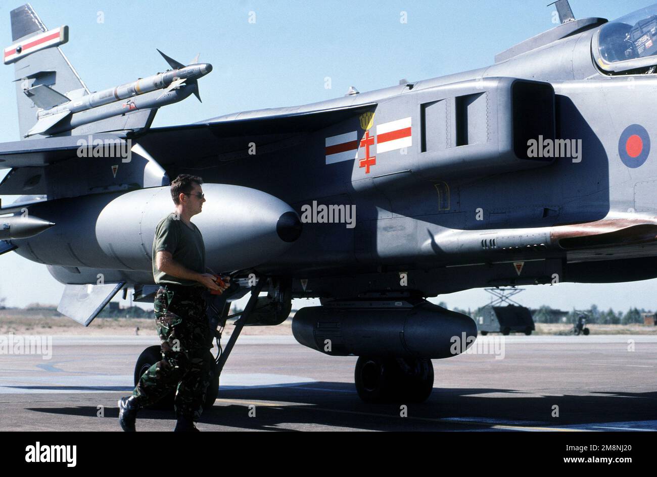 Right side profile of a Royal Air Force crew chief as he prepares a ...