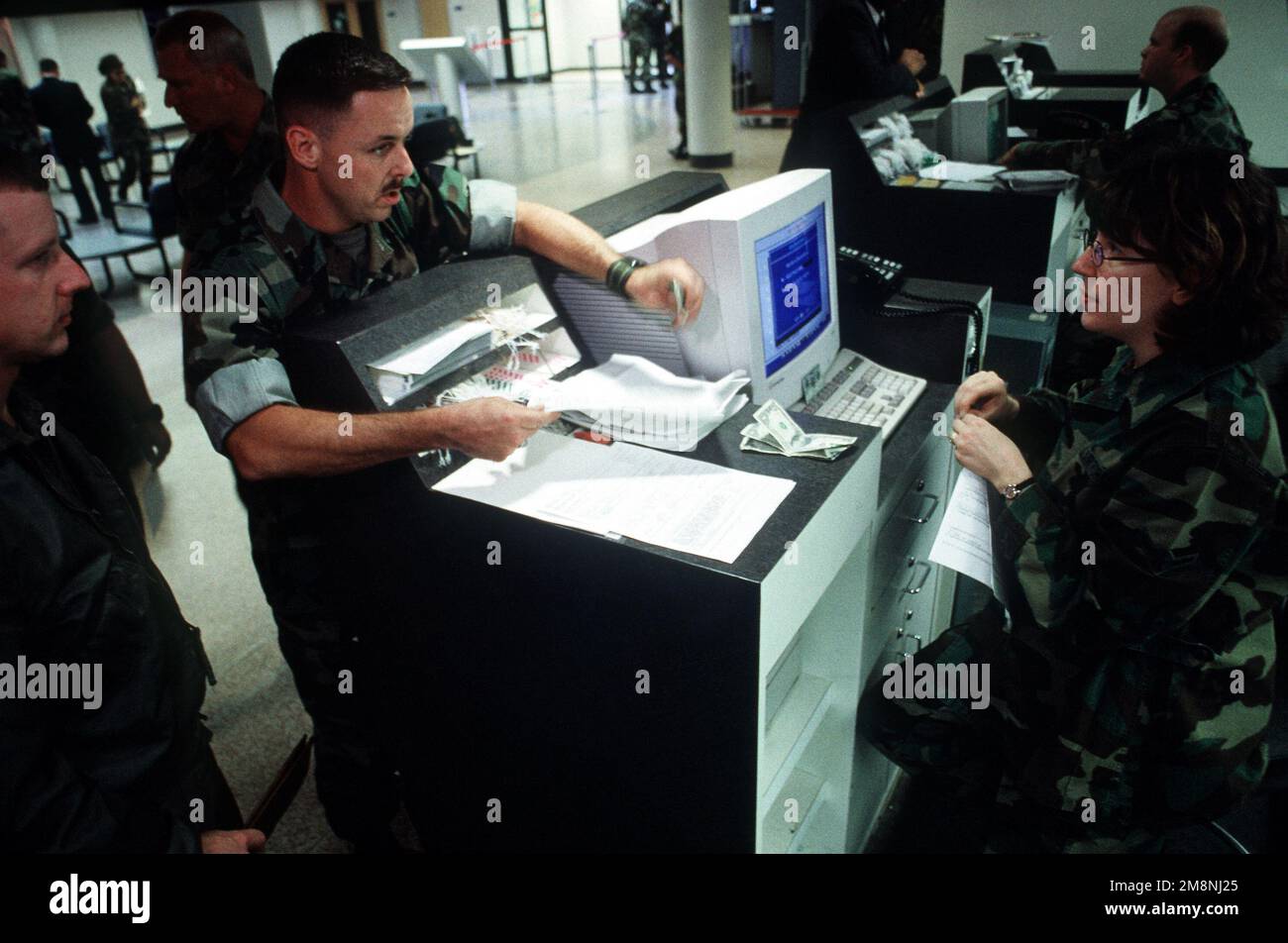 Profiled medium shot of a passenger (Left) and a USAF terminal employee ...