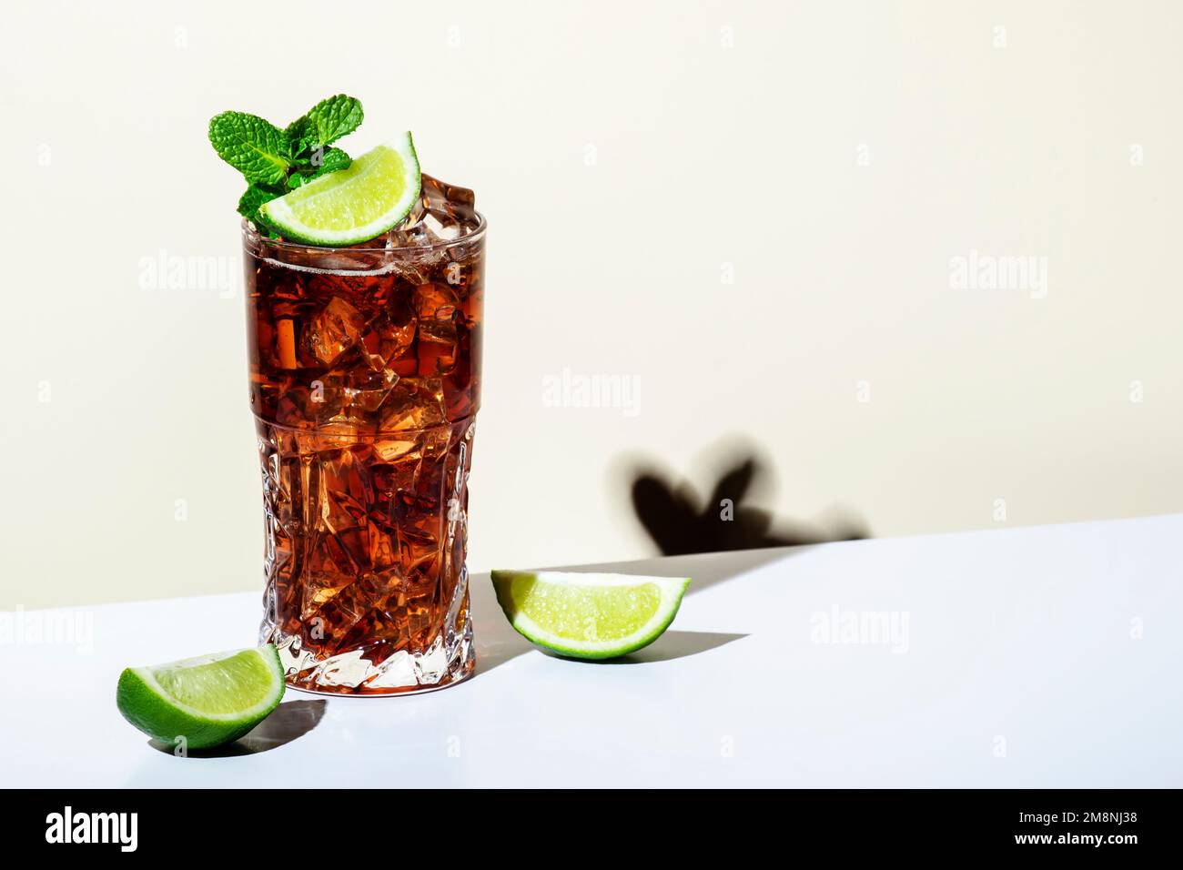 Whiskey cola cocktail with strong alcohol and ice, garnished with mint ...