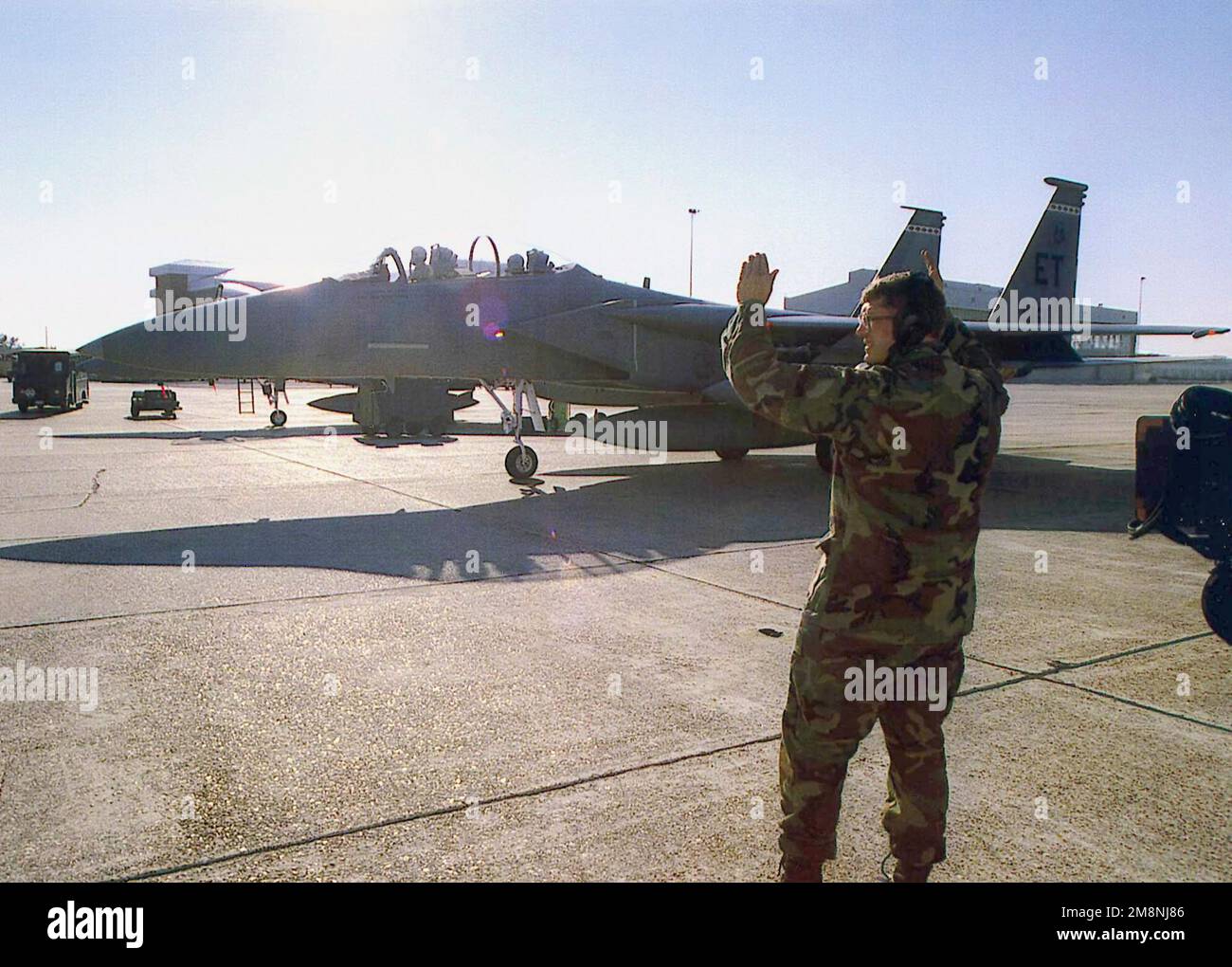 Crew chief for the 40th Flight Test Squadron marshalls an F-15 Eagle ...