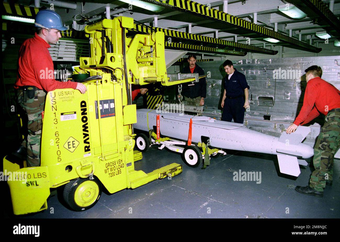 US Navy Aviation Ordnancemen from the Weapons Department aboard USS ...